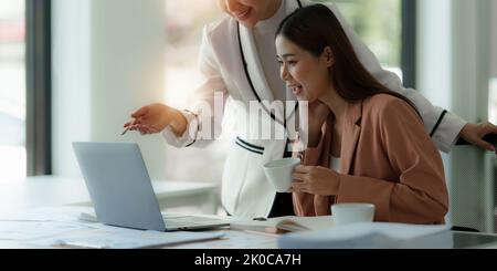 Asian Business Woman or Accountant do math and analyze with calculator ...