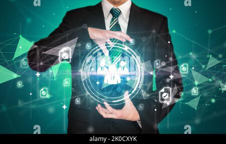 Businessman holdig business icons concept Stock Photo - Alamy