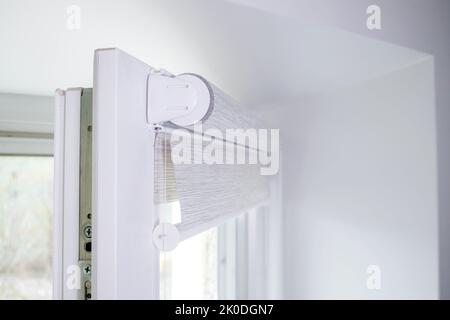 Close up mechanism of tnaninny roller blinds indoors. Duo window roller ...