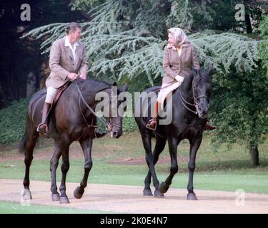 President Ronald Reagan riding horses with Queen Elizabeth II during ...