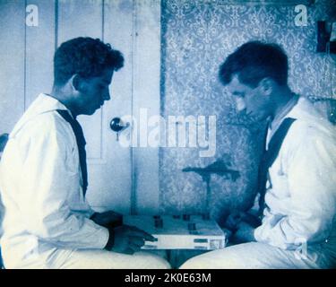 Two boys in sailor suits, playing checkers Stock Photo - Alamy
