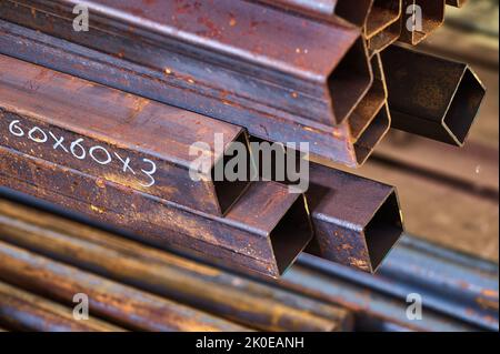 Square tubing on blurred background in cold warehouse Stock Photo - Alamy
