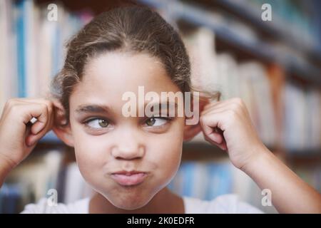 Schoolgirl pulling her ears Stock Photo - Alamy