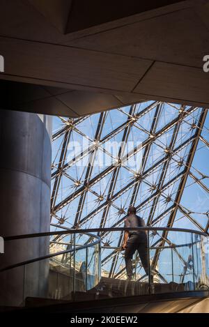 Curved staircase in the underground lobby of the Louvre pyramid of the ...