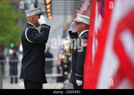 Firefighters salute each other as they stand guard at the FDNY Memorial ...
