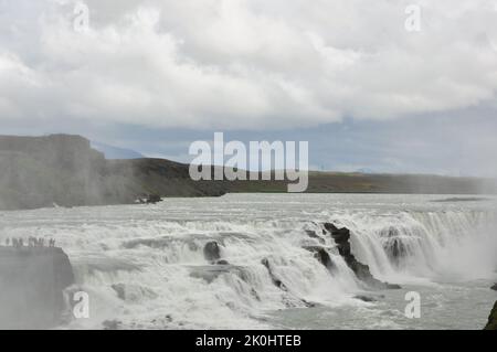 Waterfall in Iceland in cloudy weather Stock Photo - Alamy