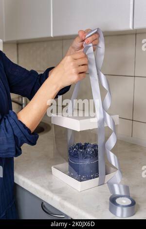 Young female seller with cake in bakery Stock Photo - Alamy