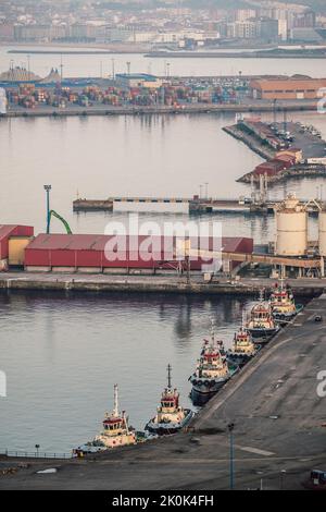 Aerial view of cargo boat with helipad moored at concrete pier on ...