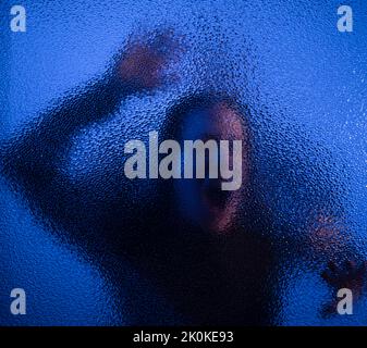 Shadow of woman screaming behind the glass, domestic violence concept ...