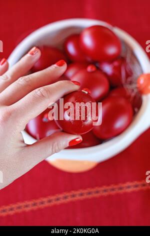 hands holding cracked red Easter eggs - Orthodox greek tradition of ...