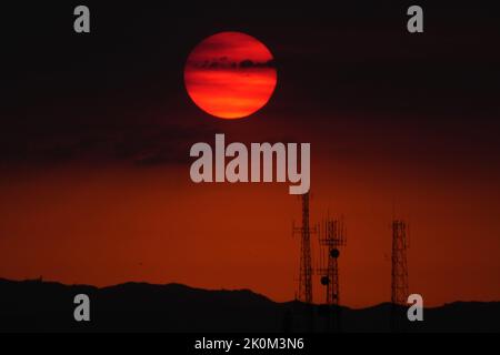 The sun sets over skies darkened by smoke from wildfires, Wednesday ...