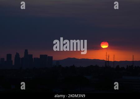 The sun sets over skies darkened by smoke from wildfires, Wednesday ...