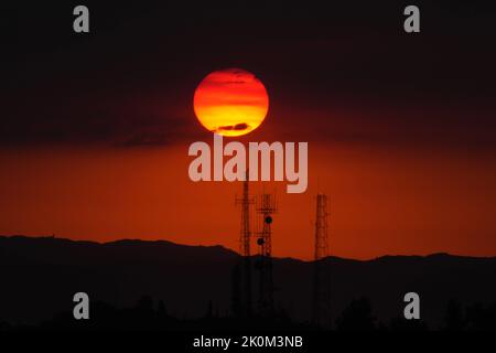 The sun sets over skies darkened by smoke from wildfires, Wednesday ...