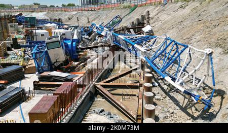 Police officers inspect the crane collapsed on a Housing Society ...