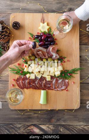 Cheese and charcuterie board in the shape of a Christmas tree. Two ...