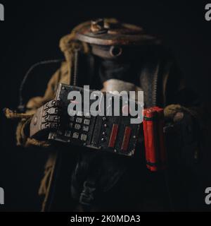 A closeup shot of a headless soldier miniature holding an old camera ...