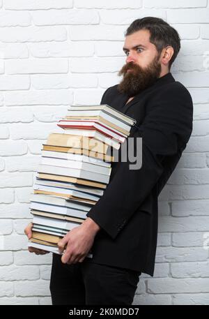 Funny teacher or professor with book stack. Thinking serious mature ...
