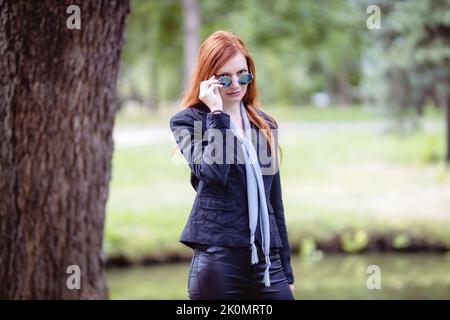 Portrait of a slender red-haired woman in a business black suit Stock ...