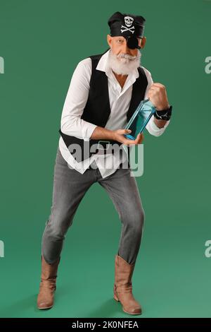 Old pirate with bottle of rum on dark background Stock Photo - Alamy