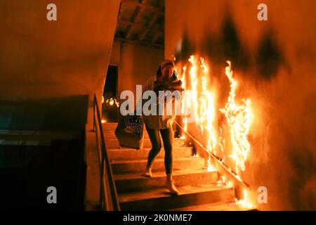 Brave Fireman Descends Stairs of a Burning Building and Holds Saved ...