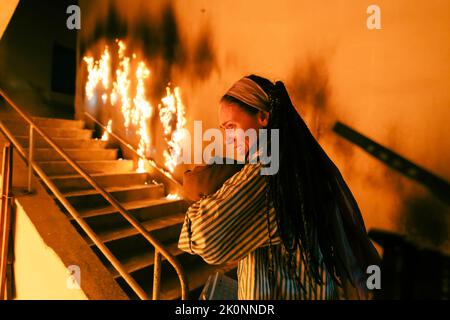 Brave Fireman Descends Stairs of a Burning Building and Holds Saved ...