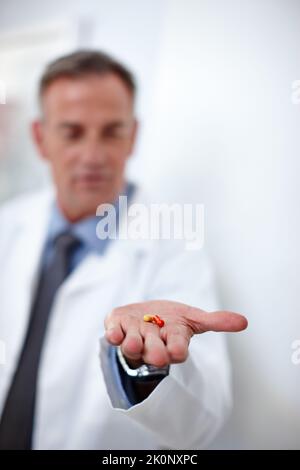 Workplace of a doctor. Pills in hand, stethoscope, clipboard and ...