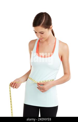 Beautiful young lady measuring her waist before a workout Stock Photo ...