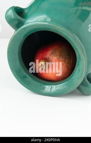 A pomegranate inside clay earthen ware Stock Photo - Alamy