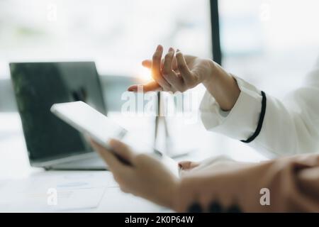 Asian Business Woman or Accountant do math and analyze with calculator ...