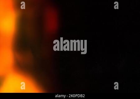 colorful warm rainbow light leaks on black background with dust texture ...