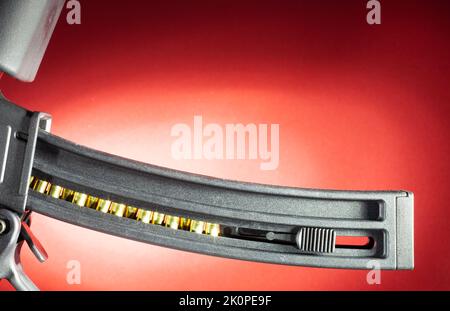 Rimfire rifle magazine loaded with ammo with copy space below on a red ...