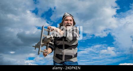 happy retirement. elder granddad with toy. retired old man outdoor ...