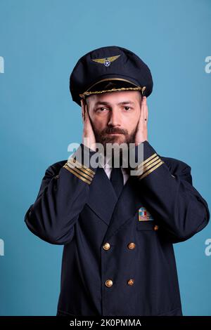 Airplane pilot covering eyes with hands, man showing see no evil moral ...