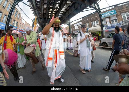 Ecstatic Hare Krishna Hindus dance & play music under the elevated ...