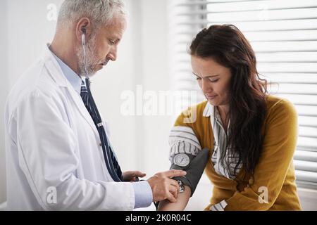 Getting his annual checkup. a mature doctor having a checkup with a ...
