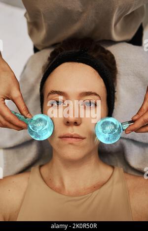 Facial massage with cold spheres Stock Photo - Alamy