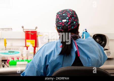 Female scientist extracting DNA using the spin column-based nucleic ...