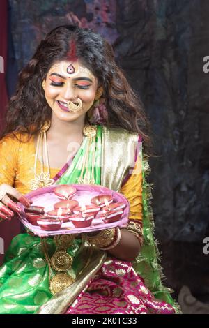 Agomoni concept photo shoot, A poses for the camera with an unfinished ...