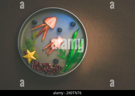 jellyfish, green plants and starfish in sea world from strawberries ...
