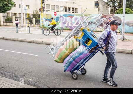 men pulling loaded cart on the street, Milan, Italy Stock Photo - Alamy