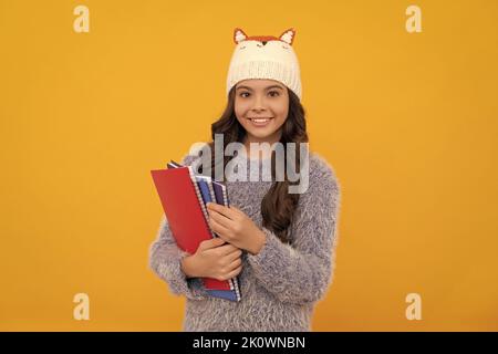 winter fashion. positive kid with curly hair in knitted scarf and ...