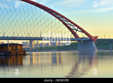 Arched bridge over the Ob. Bugrinsky automobile bridge over a floating ...