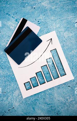 cutout graph with stats going up on blue background, concept of ...