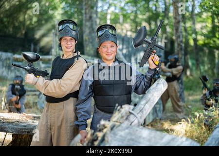 Two smiling paintball players in full gear having fun before game Stock ...