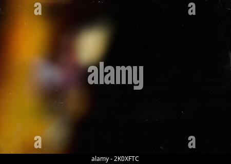 colorful warm rainbow light leaks on black background with dust texture ...