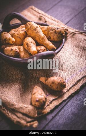 Raw jerusalem artichoke. Topinambur vegetable root on plate Stock Photo ...