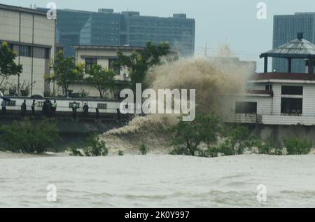 HANGZHOU, CHINA - SEPTEMBER 14, 2022 - Tourists watch the Qiantang ...