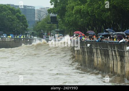 HANGZHOU, CHINA - SEPTEMBER 14, 2022 - Tourists watch the Qiantang ...