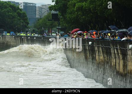 HANGZHOU, CHINA - SEPTEMBER 14, 2022 - Tourists watch the Qiantang ...