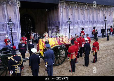 The Bearer Party carry the coffin in to the funeral for Captain ...